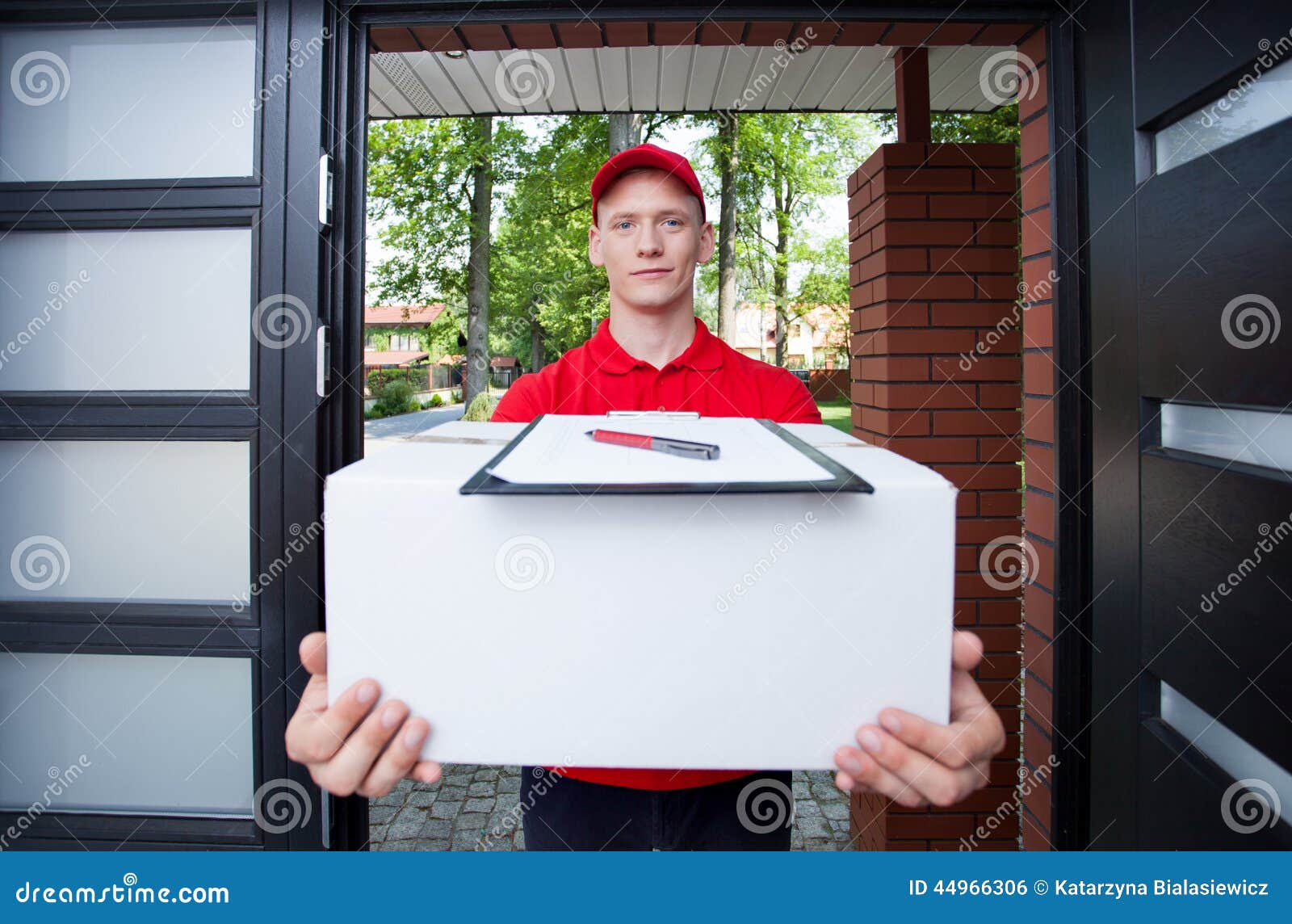 Delivery Guy Handing in Parcel Stock Photo - Image of carton, home ...