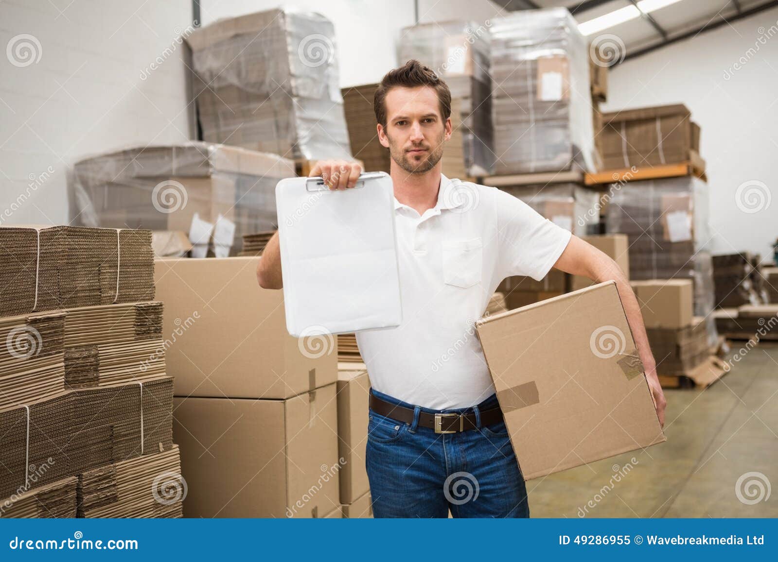 Delivery Man with Box and Clipboard in Warehouse Stock Image - Image of ...