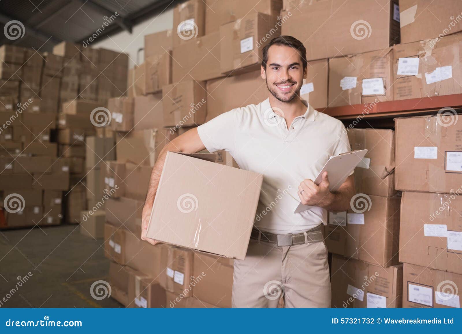 Delivery Man with Box and Clipboard in Warehouse Stock Photo - Image of ...