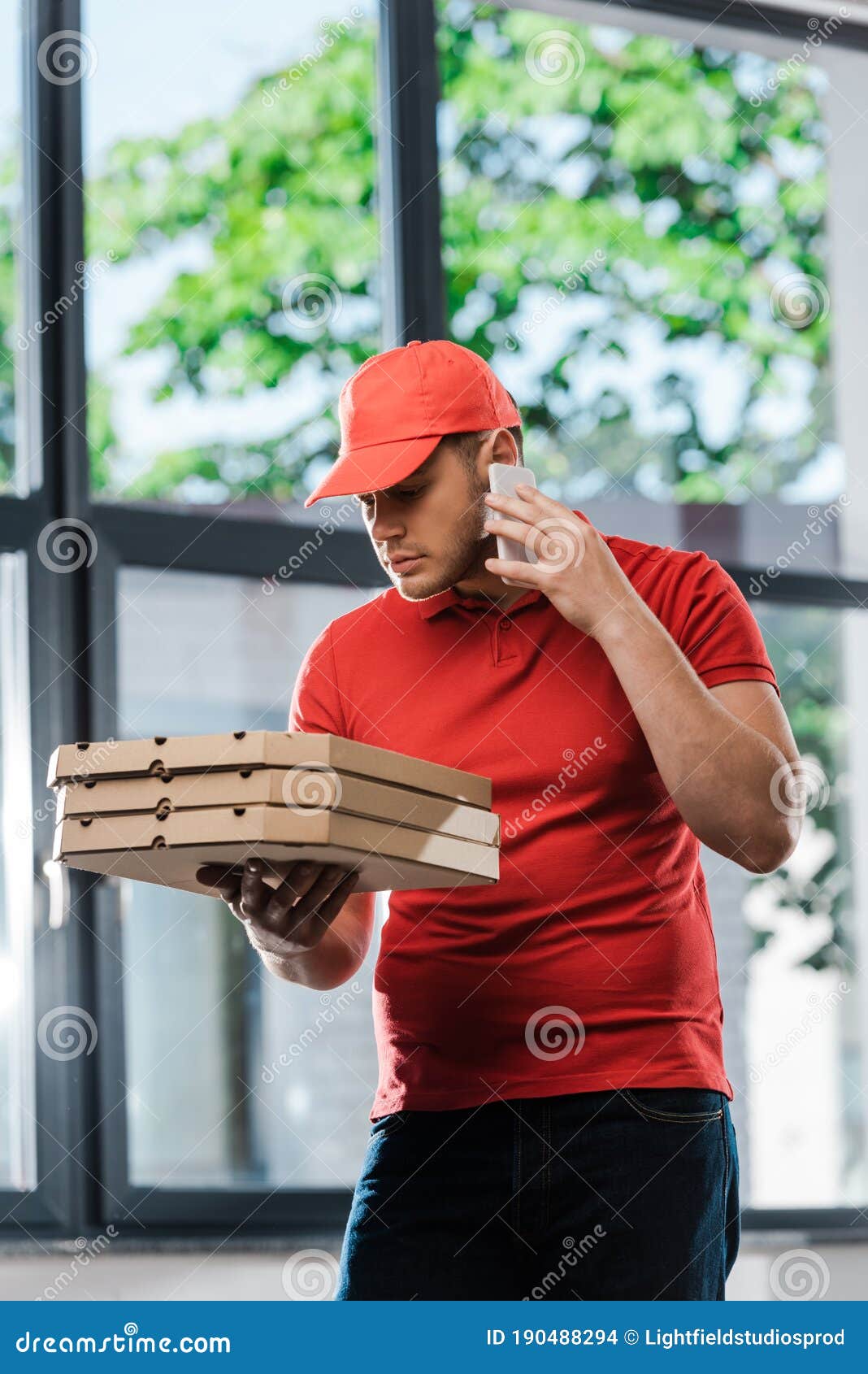 Delivery Man in Cap Talking on Stock Photo - Image of smartphone, talk ...