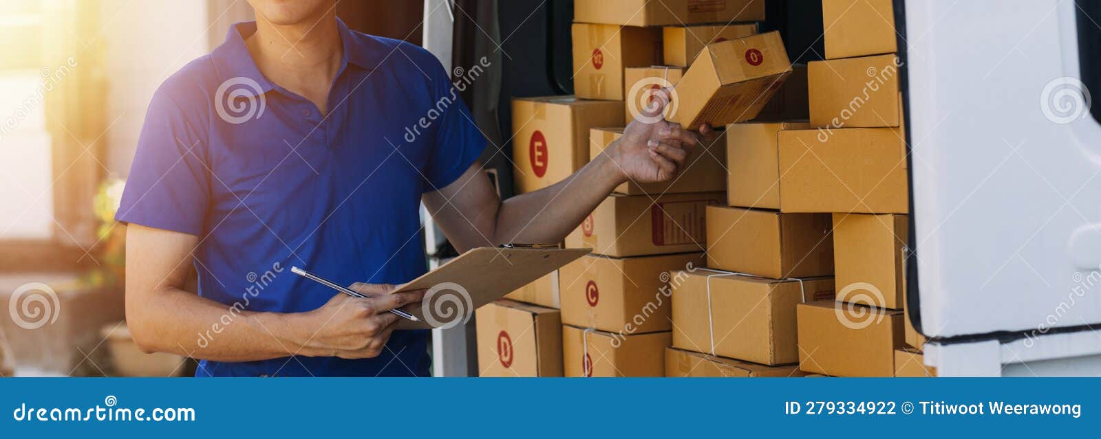 Delivery Man with Cardboard Box Checking Document List in Van and ...