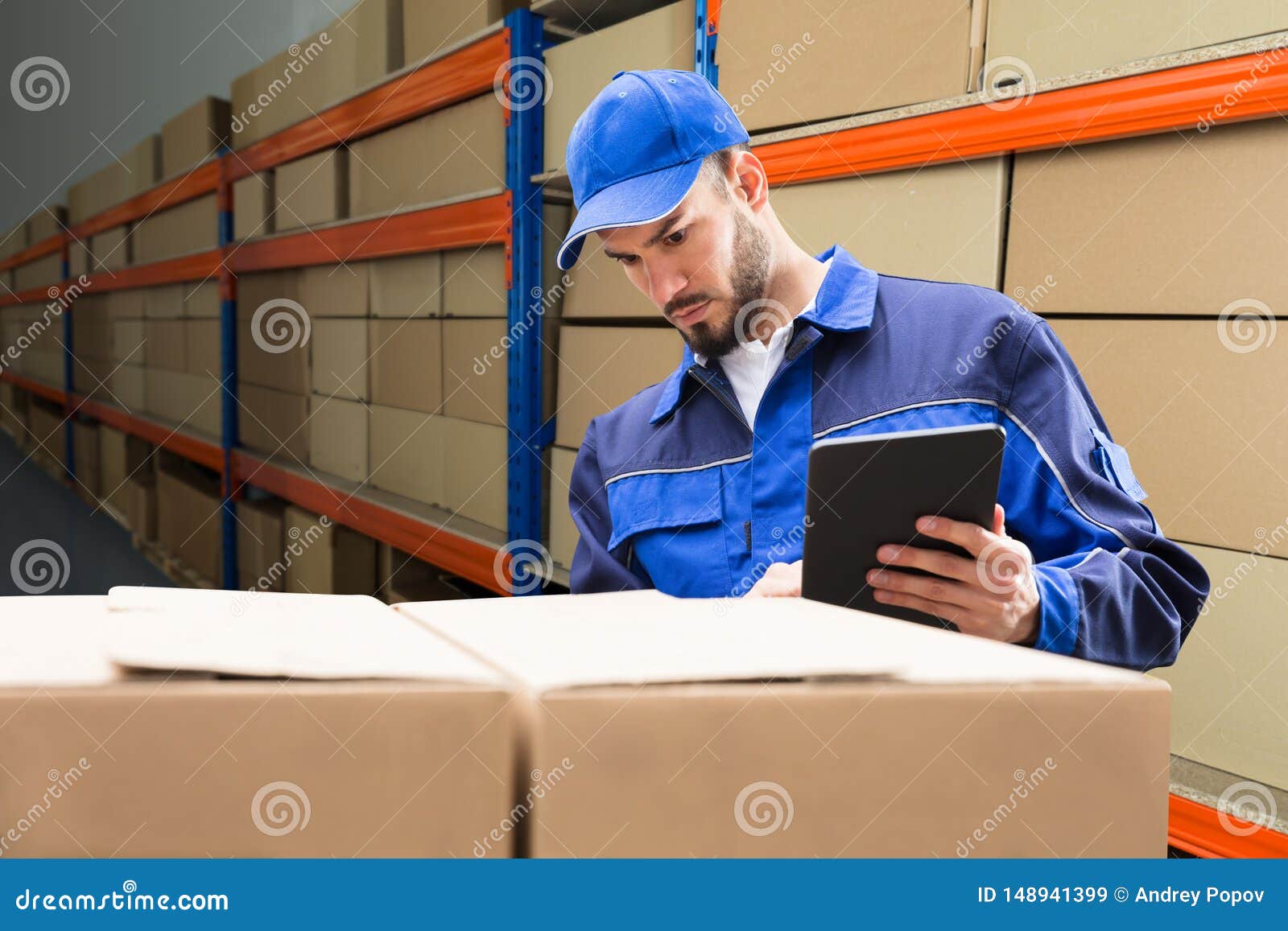 Delivery Man Checking His Package on Digital Tablet Stock Image - Image ...