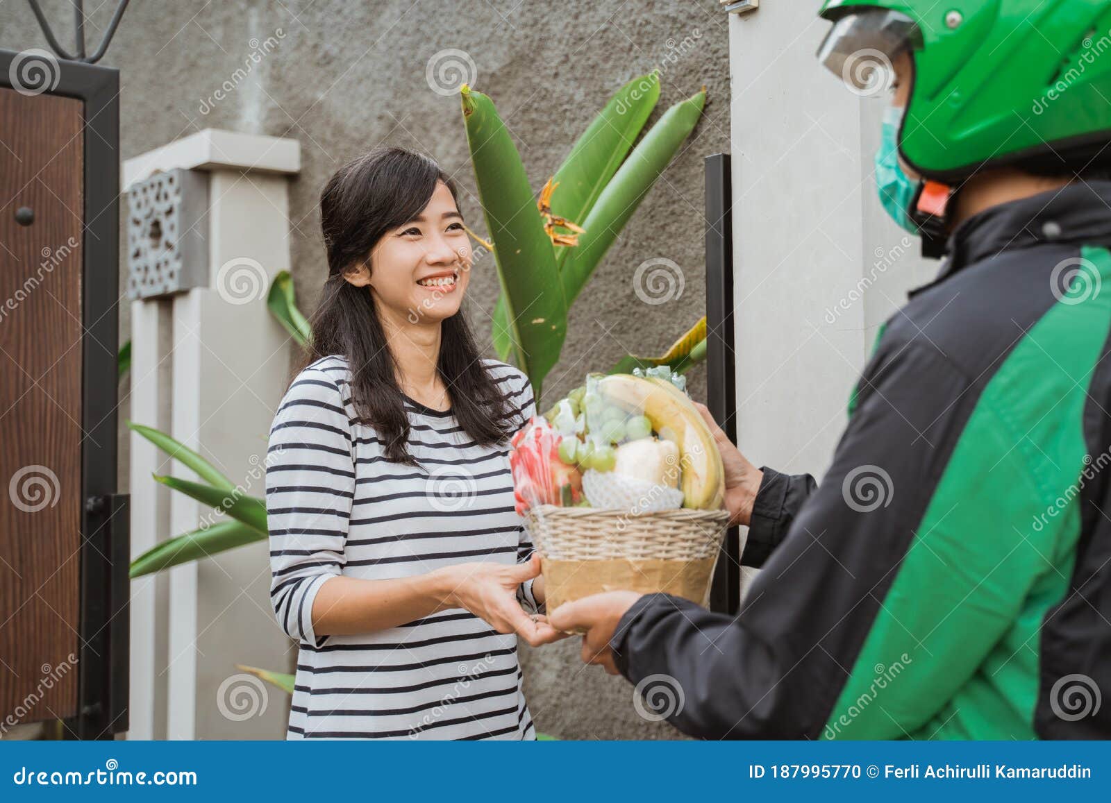Delivery Man Delivering Fruit Parcel Stock Photo - Image of jacket ...
