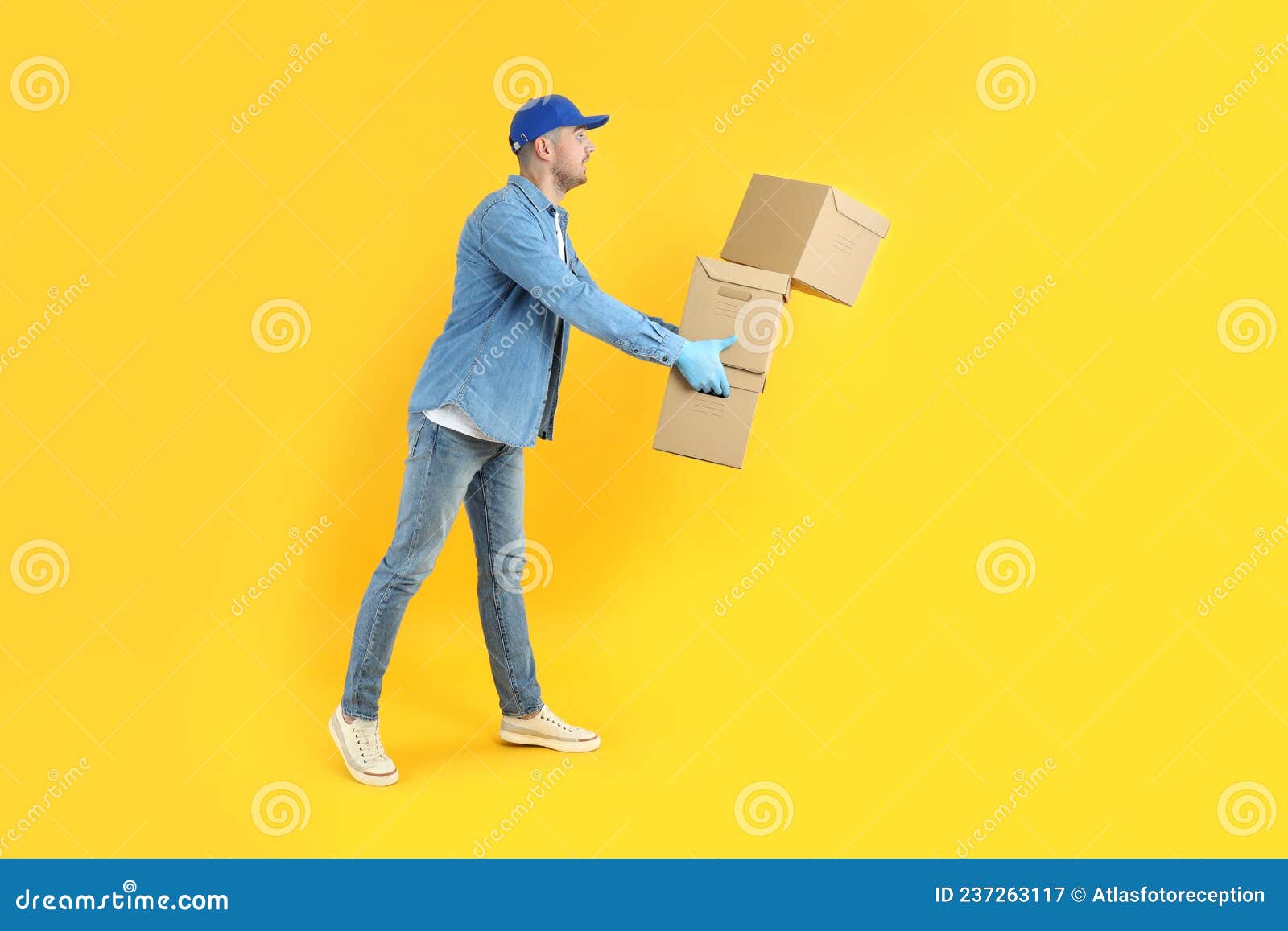 Delivery Man With Falling Boxes On Yellow Background Royalty-Free Stock ...
