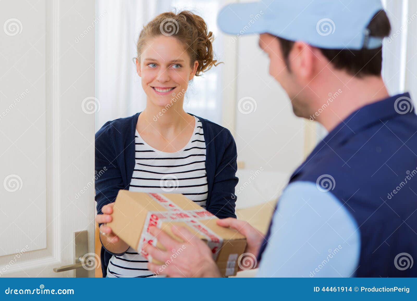 Delivery Man Handing Over a Parcel To Customer Stock Photo - Image of ...