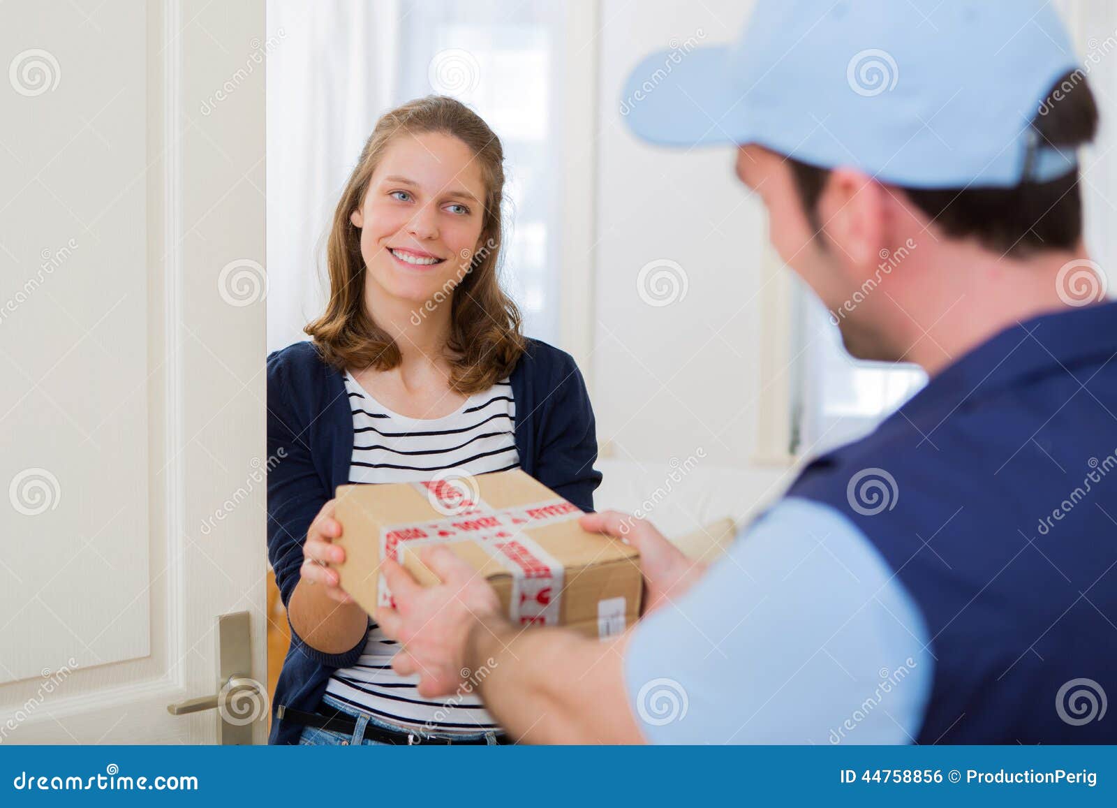 Delivery Man Handing Over a Parcel To Customer Stock Photo - Image of ...