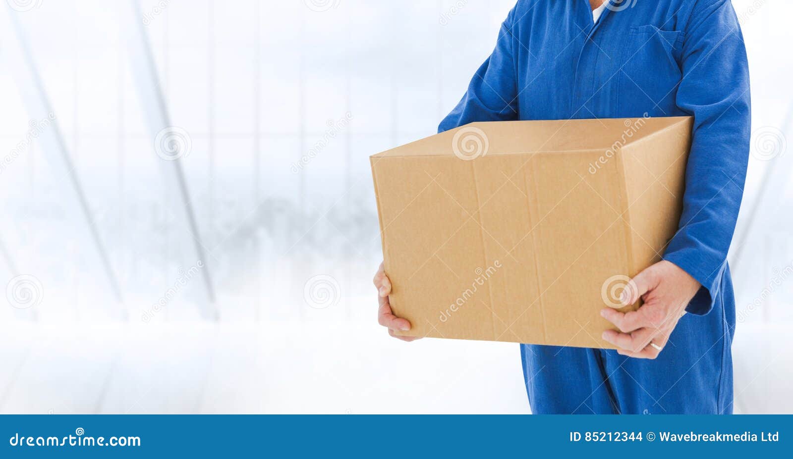 Delivery Man Holding a Box Against White Background Stock Photo - Image ...