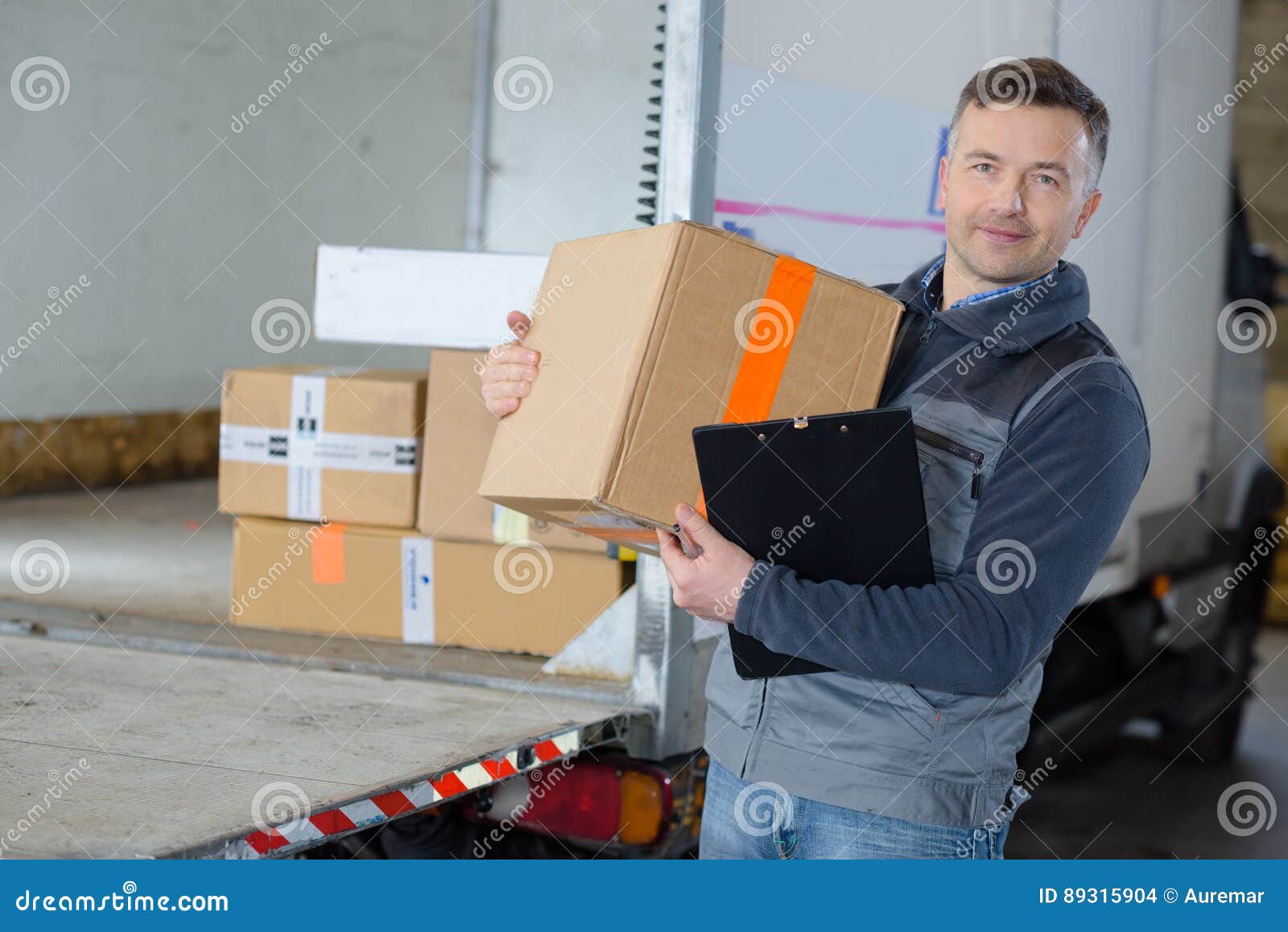 Delivery Man Holding Box in Front Truck Stock Photo - Image of style ...
