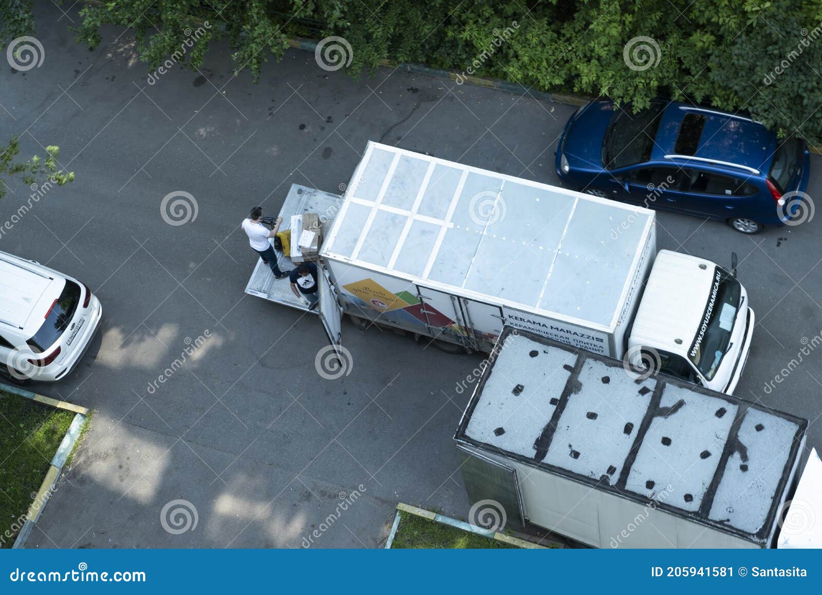 Delivery Man Holding Cardboard Box and Unloading Parcel for Delivery ...