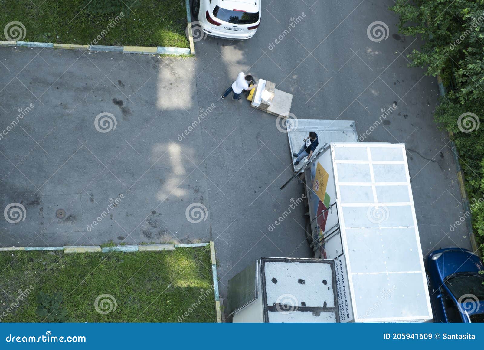 Delivery Man Holding Cardboard Box and Unloading Parcel for Delivery ...