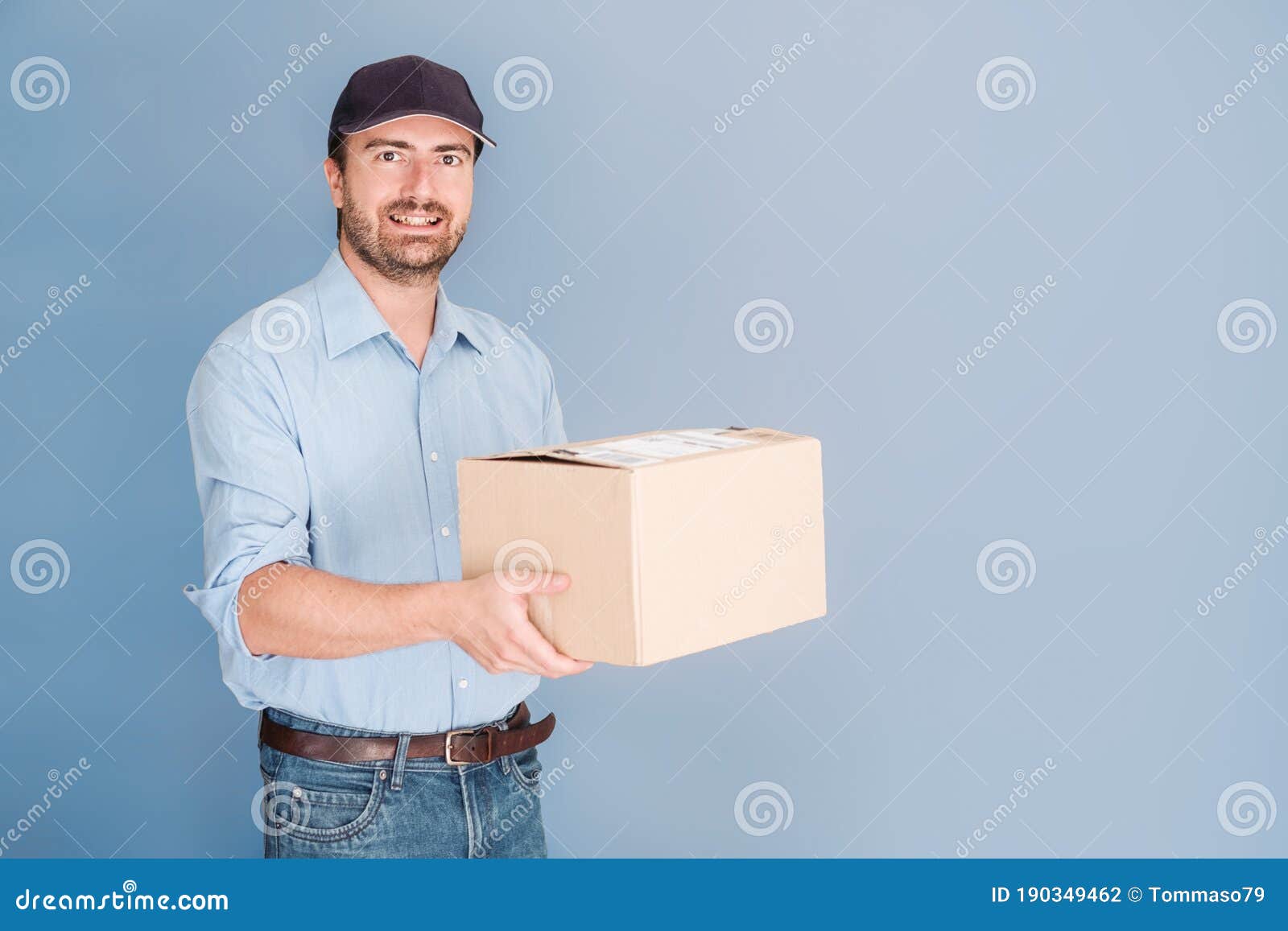 Delivery Man Holding Package on Background Stock Photo - Image of ...