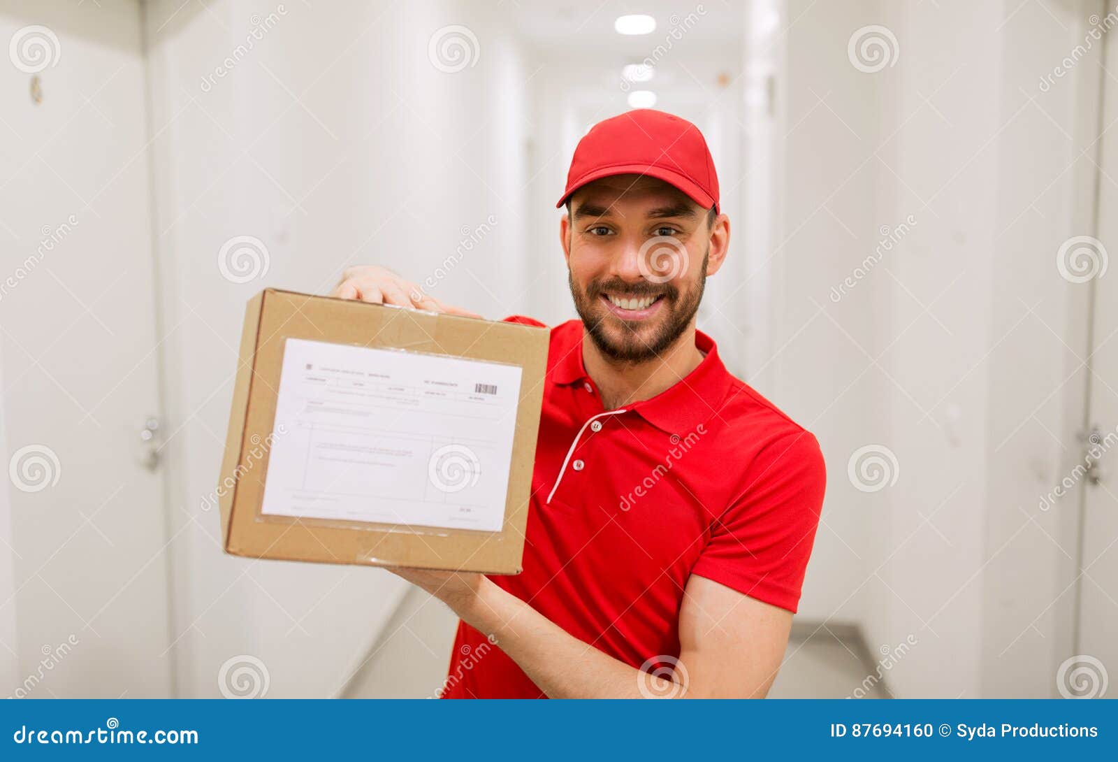 Delivery Man with Parcel Box in Corridor Stock Photo - Image of indoors ...