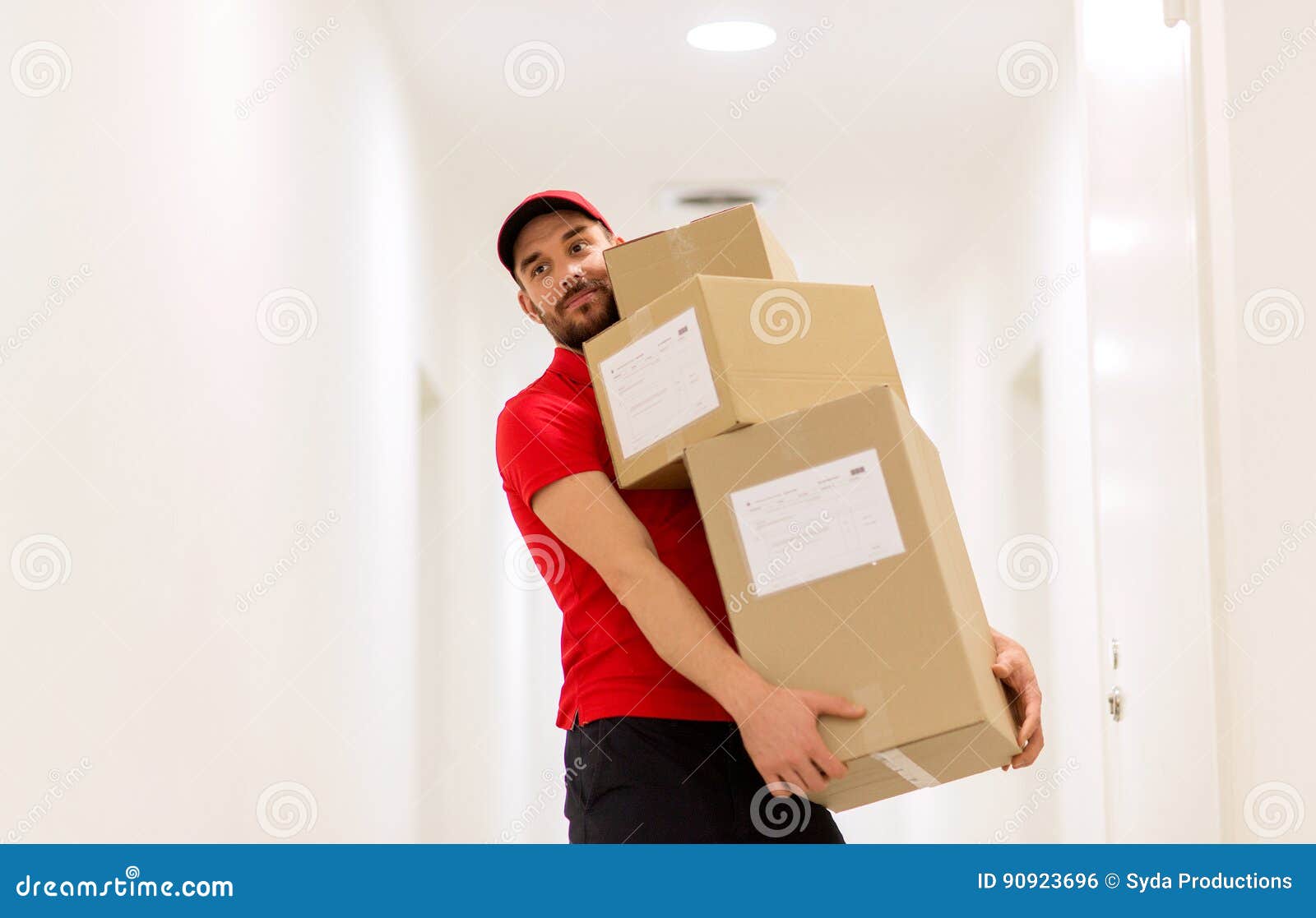 Delivery Man with Parcel Boxes in Corridor Stock Photo - Image of ...