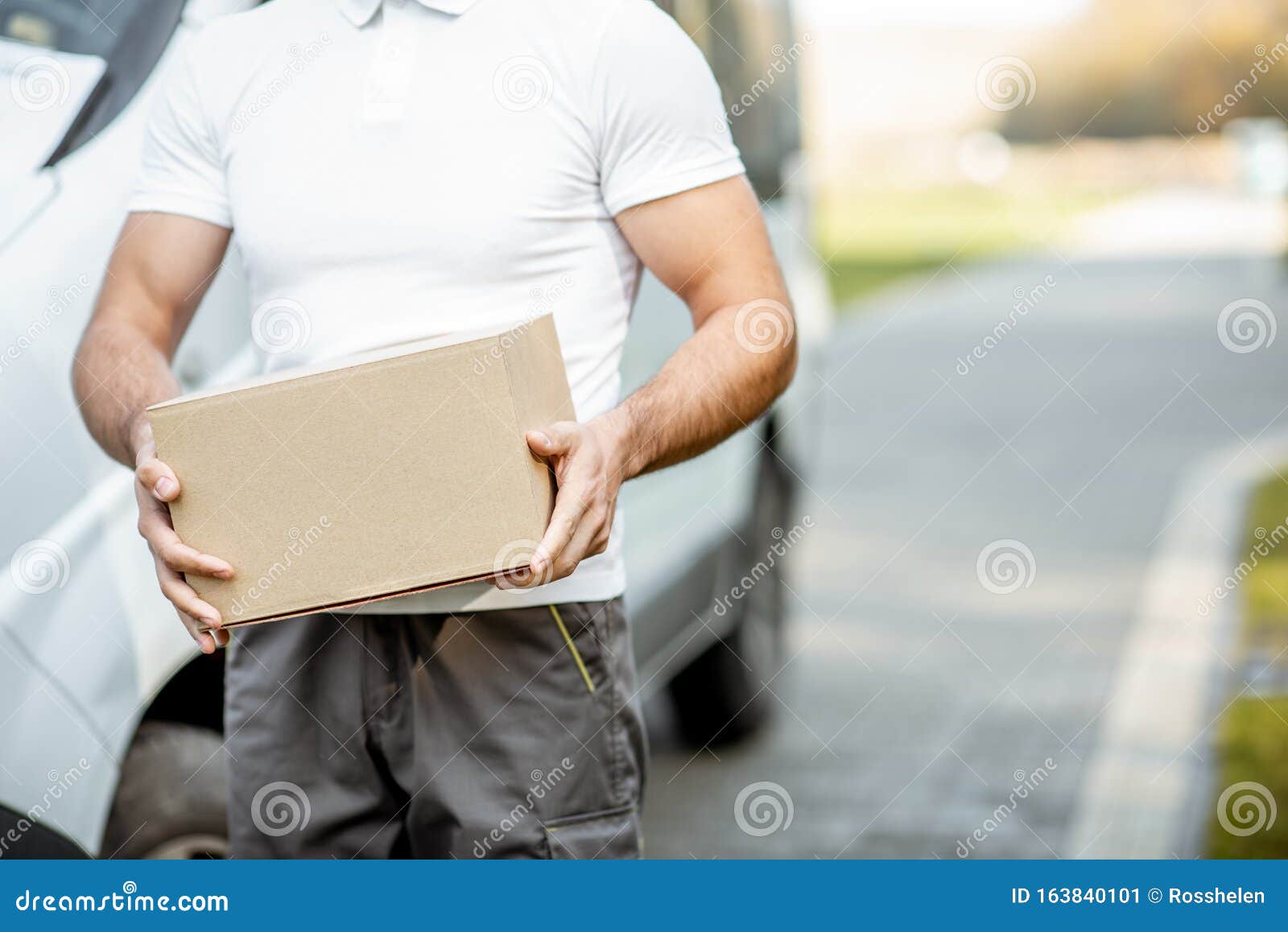 Delivery Man with Parcel Outdoors Stock Image - Image of space ...