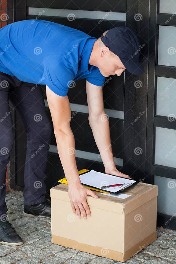 Delivery Man Putting Down Parcel Stock Photo - Image of documents ...