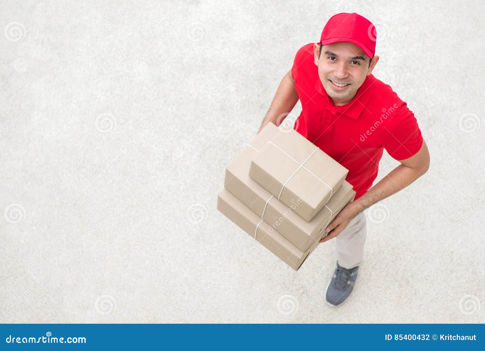 Delivery Man in Red Uniform Holding Box Stock Photo - Image of post ...