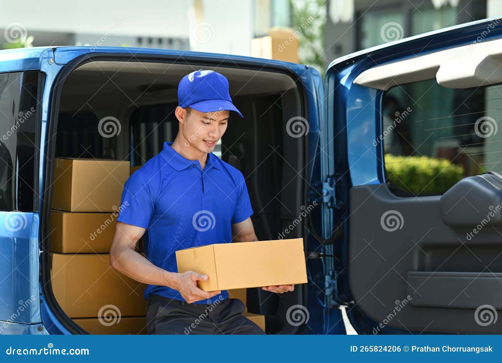 Delivery Man Sitting in Open Delivery Van and Checking Checking Address ...