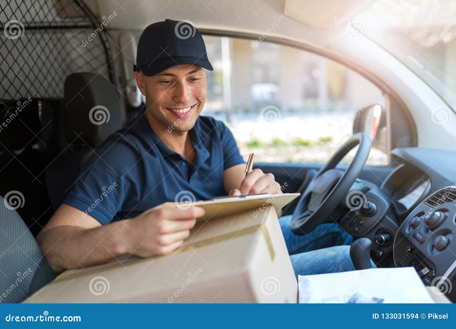 Delivery Man Sitting in a Delivery Van Stock Photo - Image of boxes ...