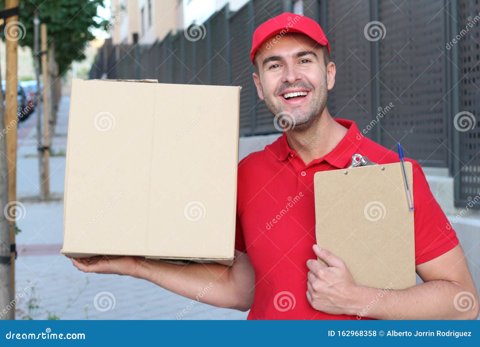Delivery Man Smiling at Work Stock Photo - Image of holding, order ...