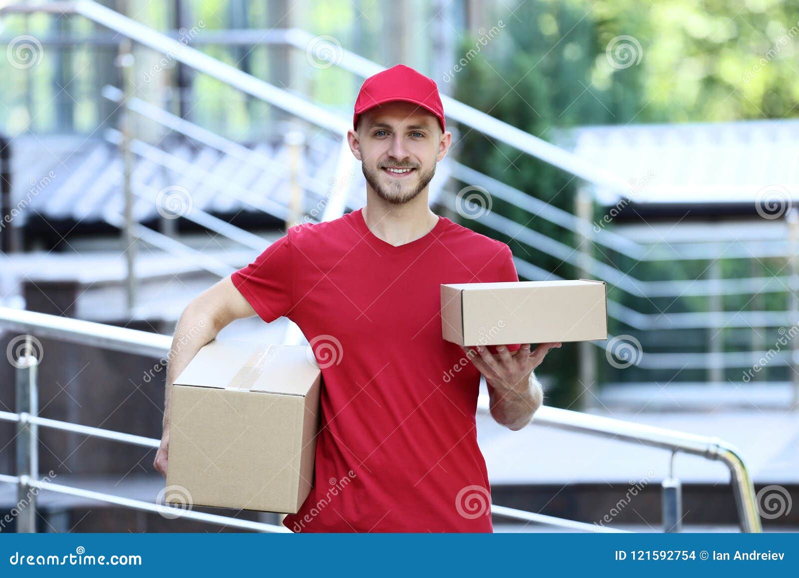 Delivery man in uniform stock photo. Image of carry - 121592754
