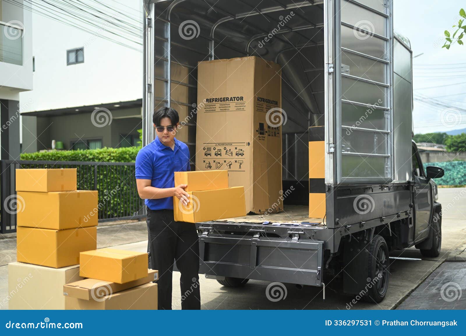 Delivery Man Unloading Packages from the Back of a Truck ...