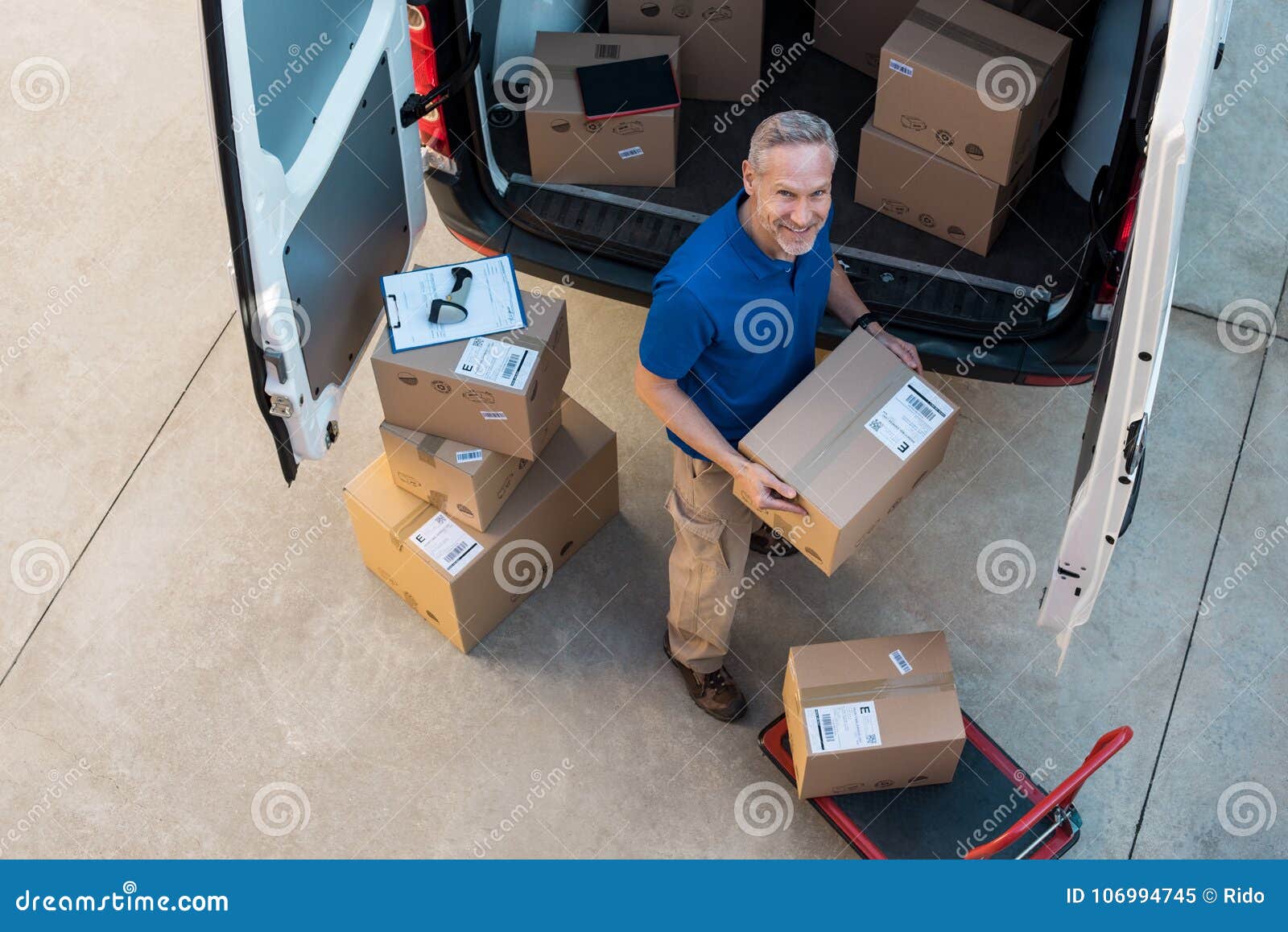 Delivery Man Unloading Parcel Stock Image - Image of people, carrying ...