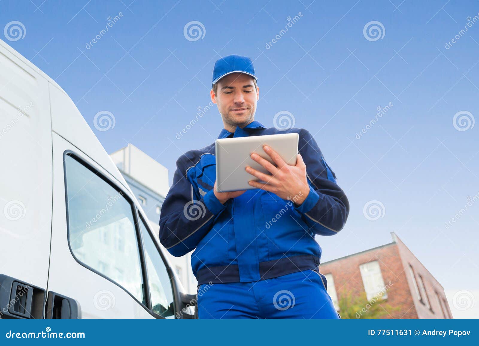 Delivery Man Using Digital Tablet by Truck Against Sky Stock Image ...