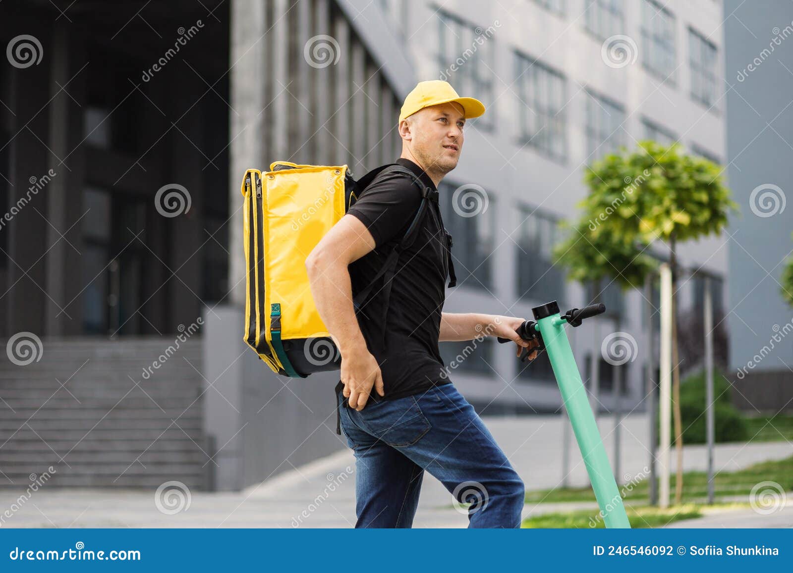 Delivery Man Using Smartphone and Riding Push Scooter in the City ...