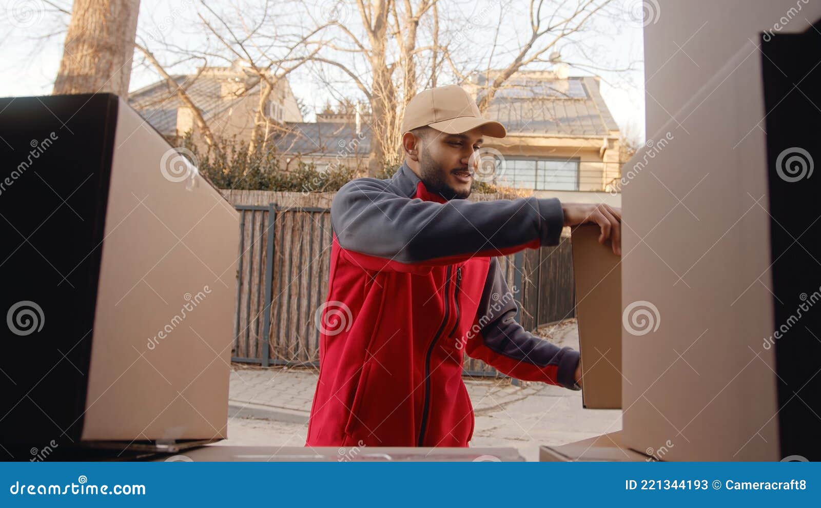 Delivery Man Wearing Cap Lifting Cardboard Boxes - Stack of Parcel ...