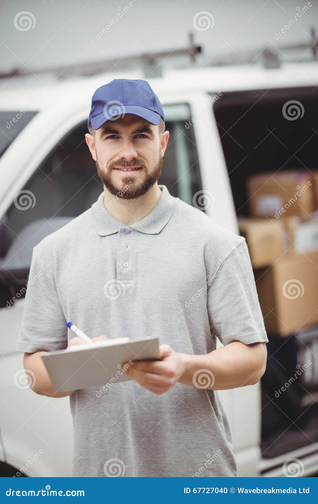 Delivery Man Writing on Clipboard Stock Photo - Image of shipment ...