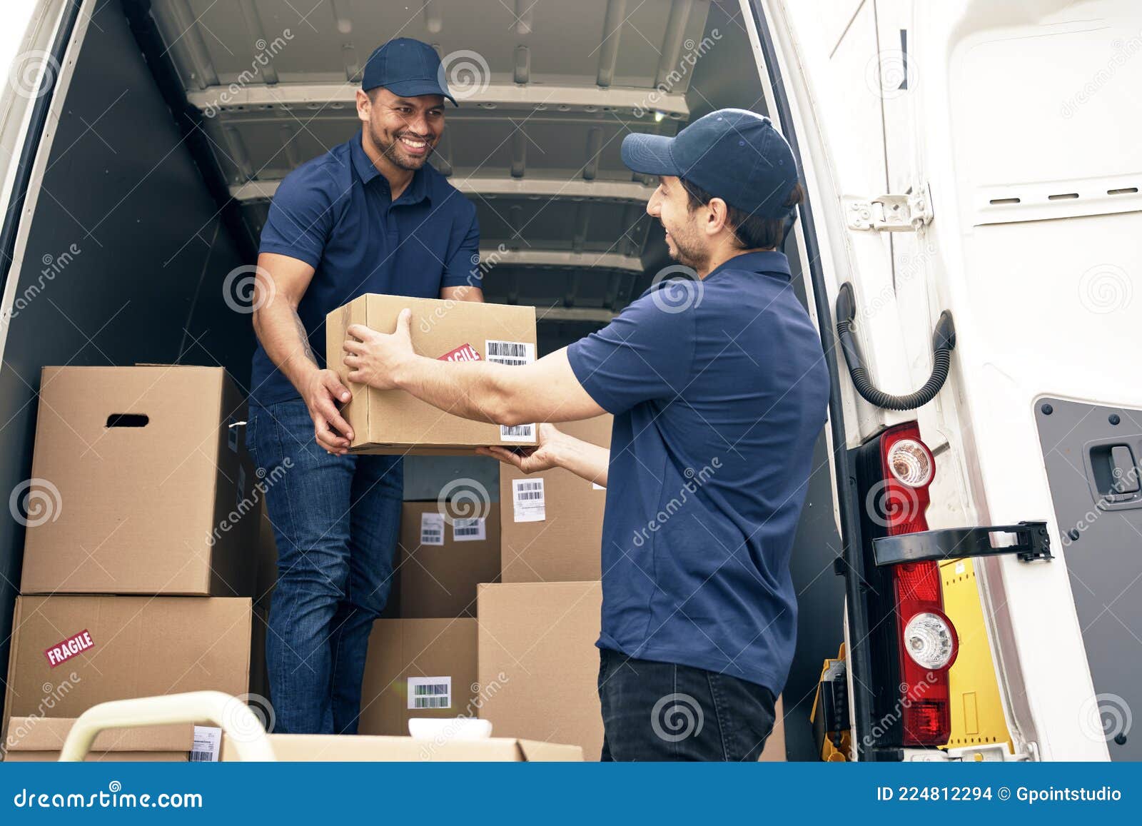 Delivery men at work stock photo. Image of packages - 224812294