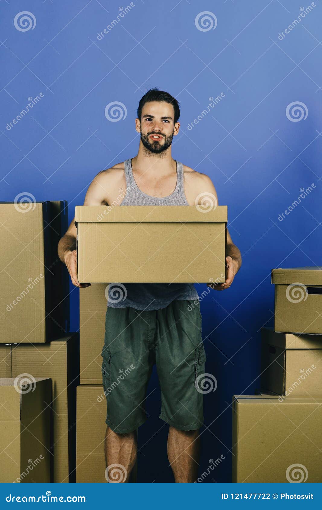 Delivery And Moving In Concept Man Standing Among Cardboard Boxes
