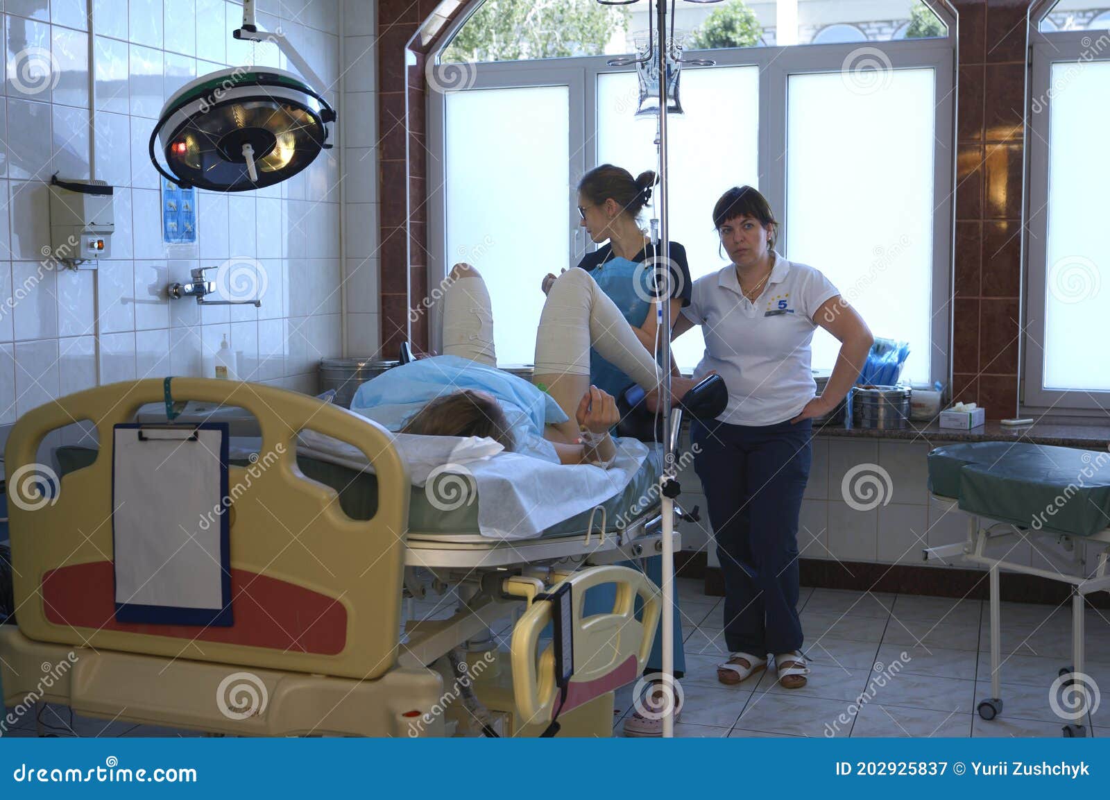 At The Delivery Room Woman Giving Birth Lying In The Chair Doctors