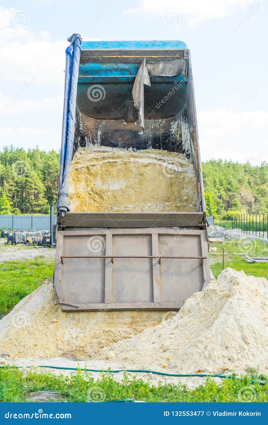 Delivery of Sand for Construction. Dump Truck Unloads the Sand Stock ...