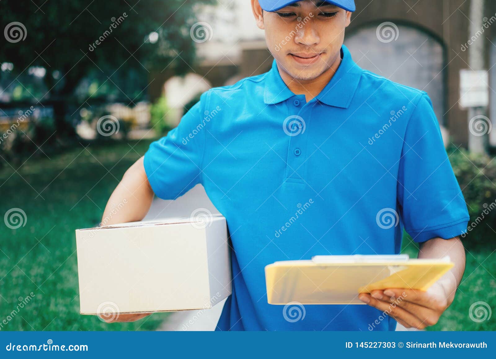 Delivery Service Courier Standing in Front of the House with Boxes ...