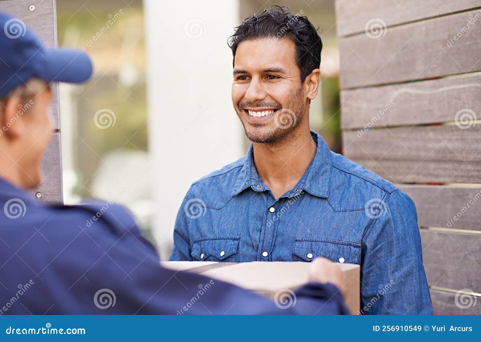 Delivery with a Smile. a Friendly Delivery Man Delivering a Package To ...