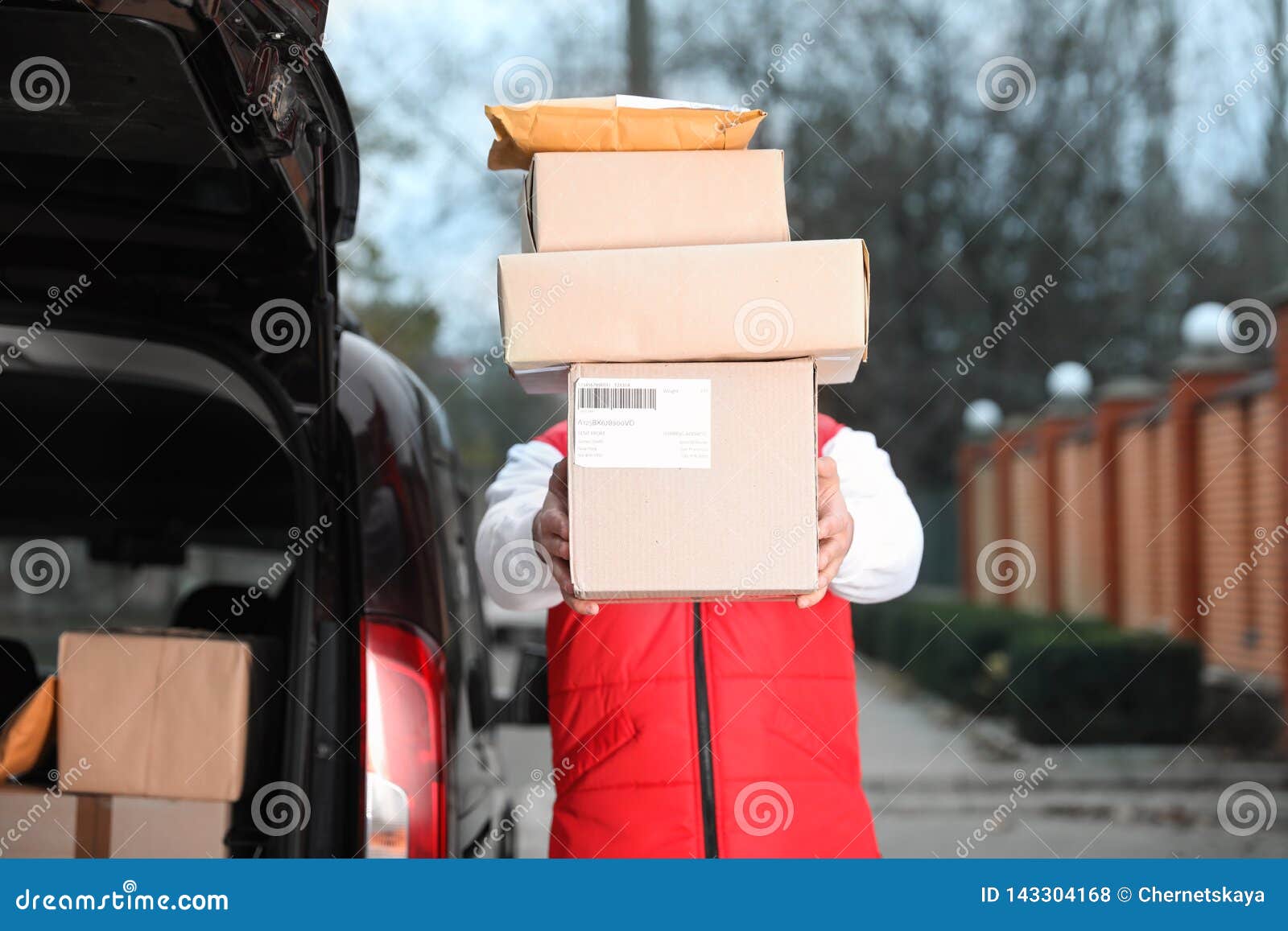 Deliveryman Holding Stack of Parcels Near Van Stock Photo - Image of ...