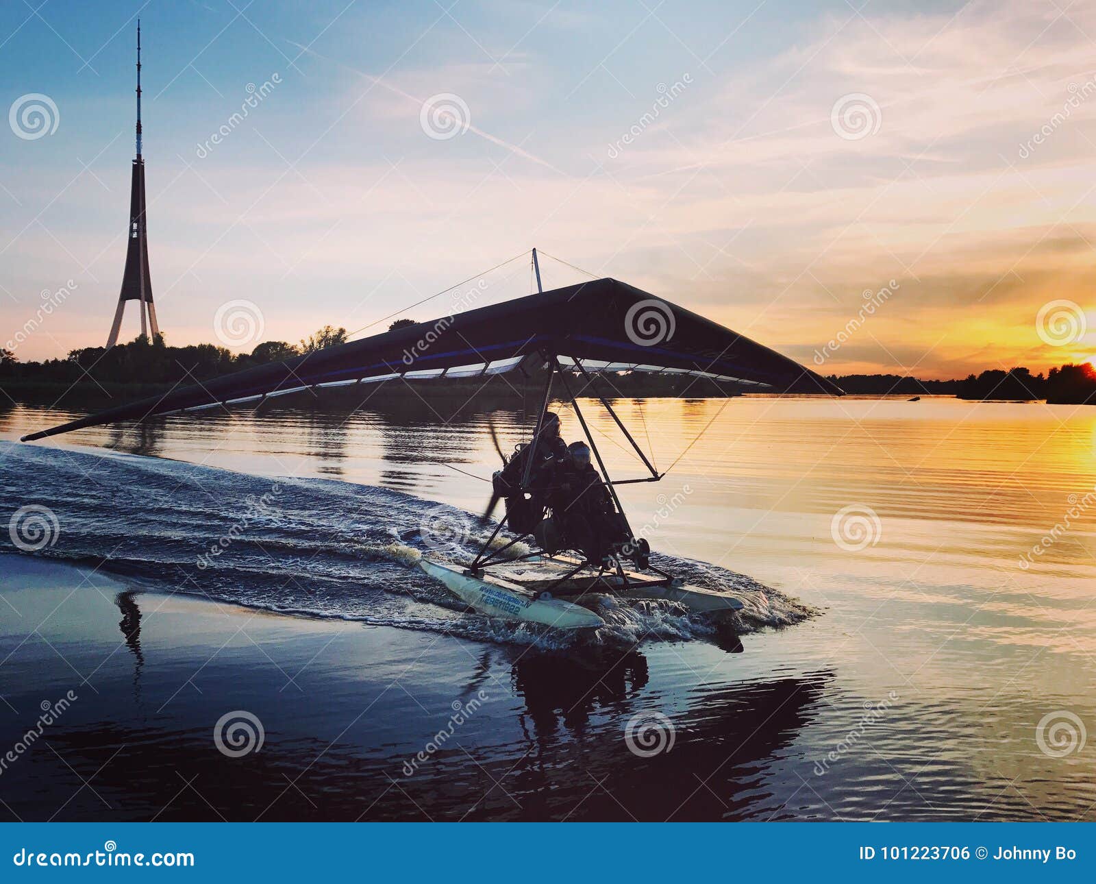Deltaplane on the river editorial photo. Image of sunset - 101223706