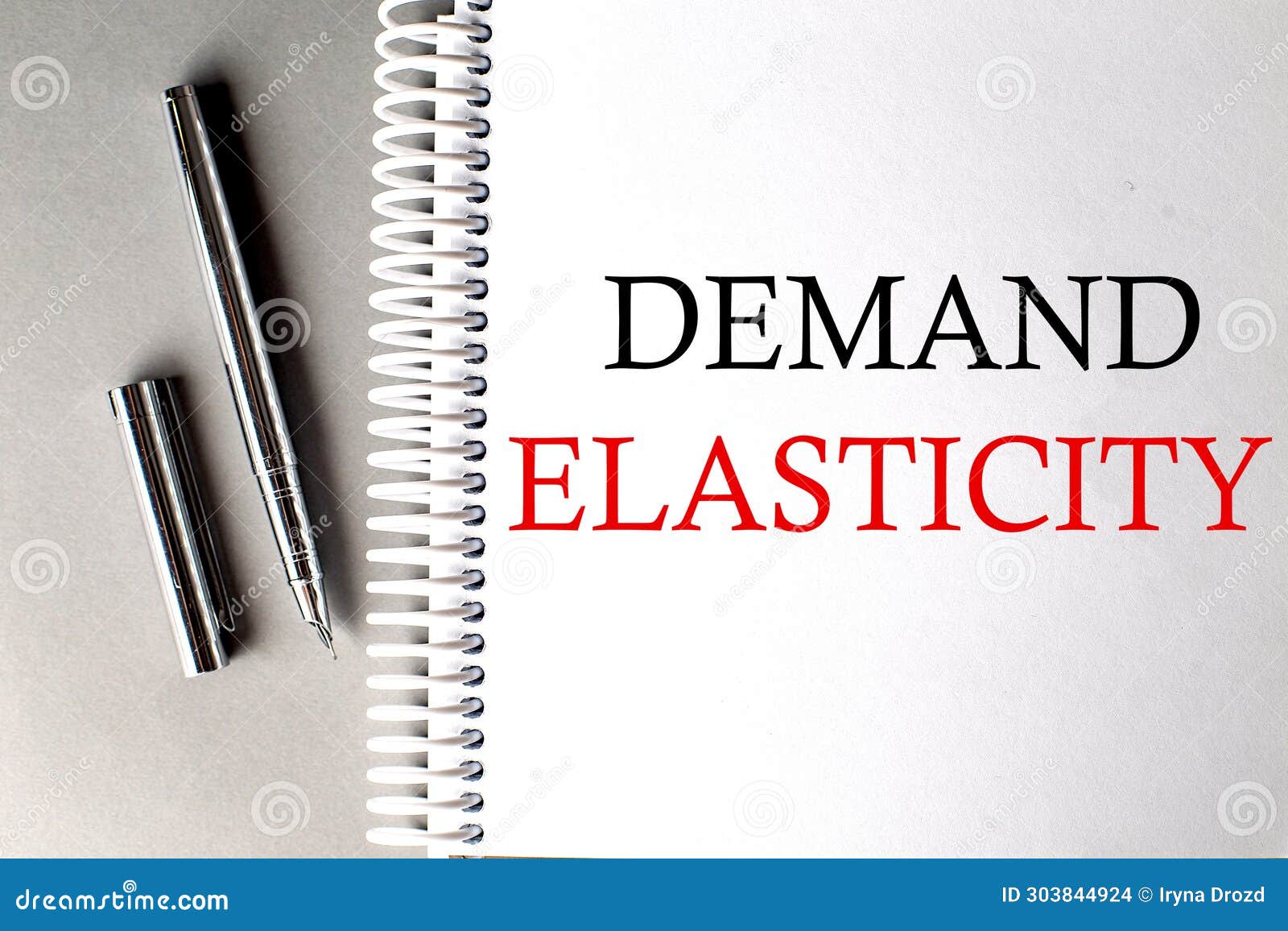 DEMAND ELASTICITY Text on a Notebook with Pen on Grey Background Stock ...