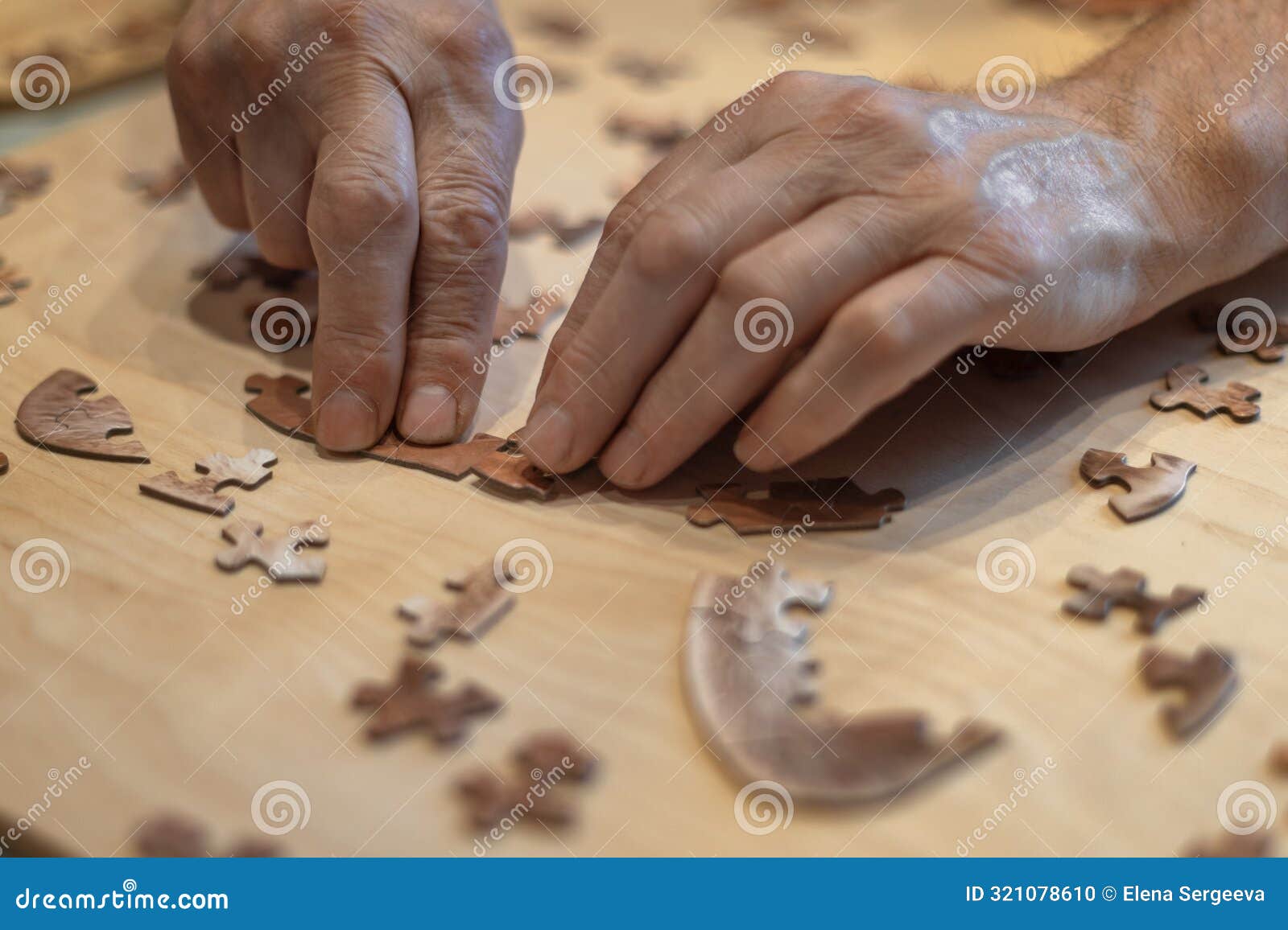 Dementia Prevention. Elderly Man Hands Doing Jigsaw Puzzle at Home ...