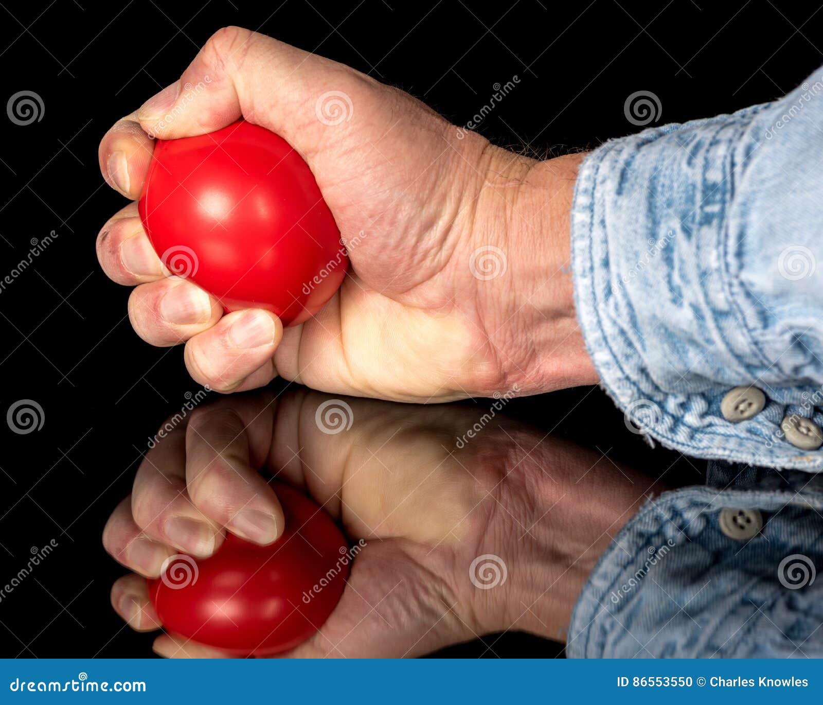 Demonstrating Squeezing a Red Stress Ball Stock Photo - Image of smart ...