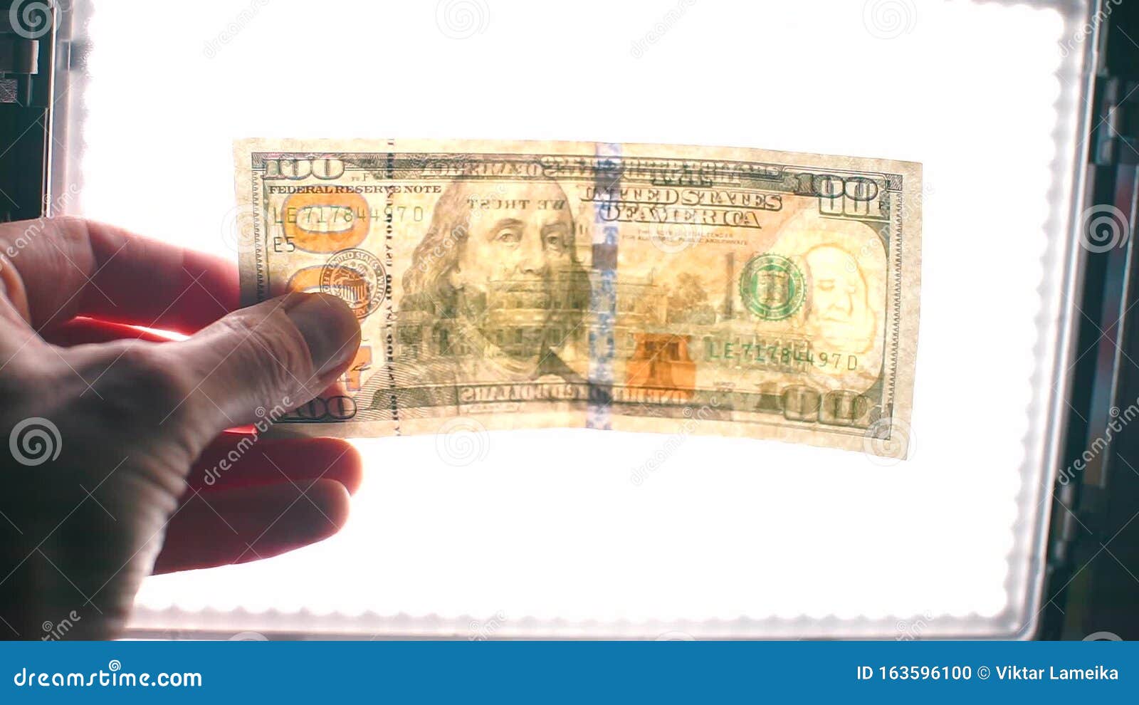 Demonstration of a Real Hundred Dollar Bill in Bright Light. Stock ...