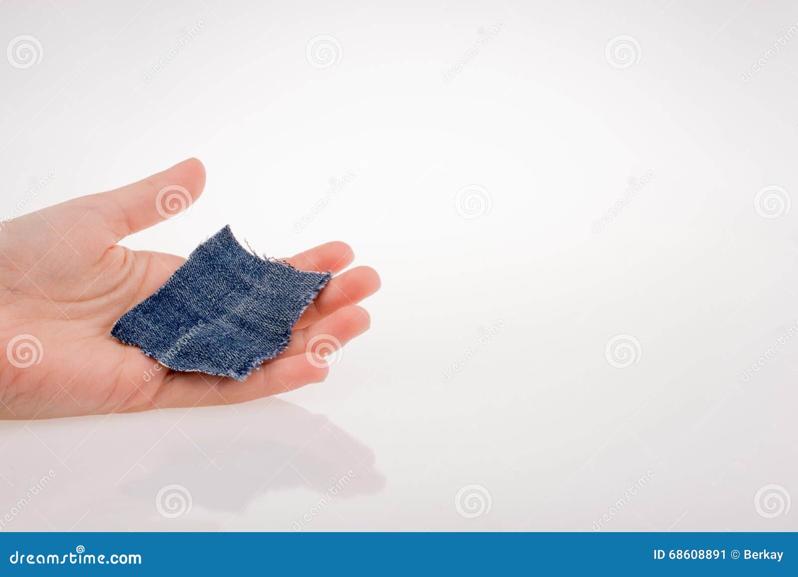 Denim fabric piece in hand stock image. Image of detail - 68608891