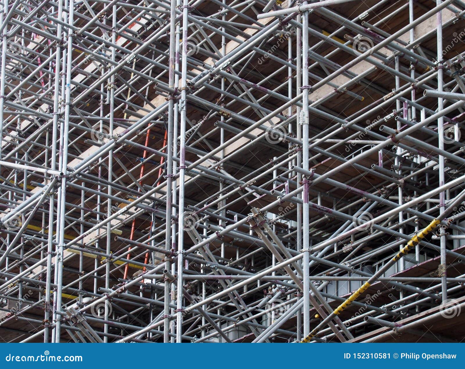 A Dense Network of Metal Scaffolding Poles Supporting Work Platforms on ...