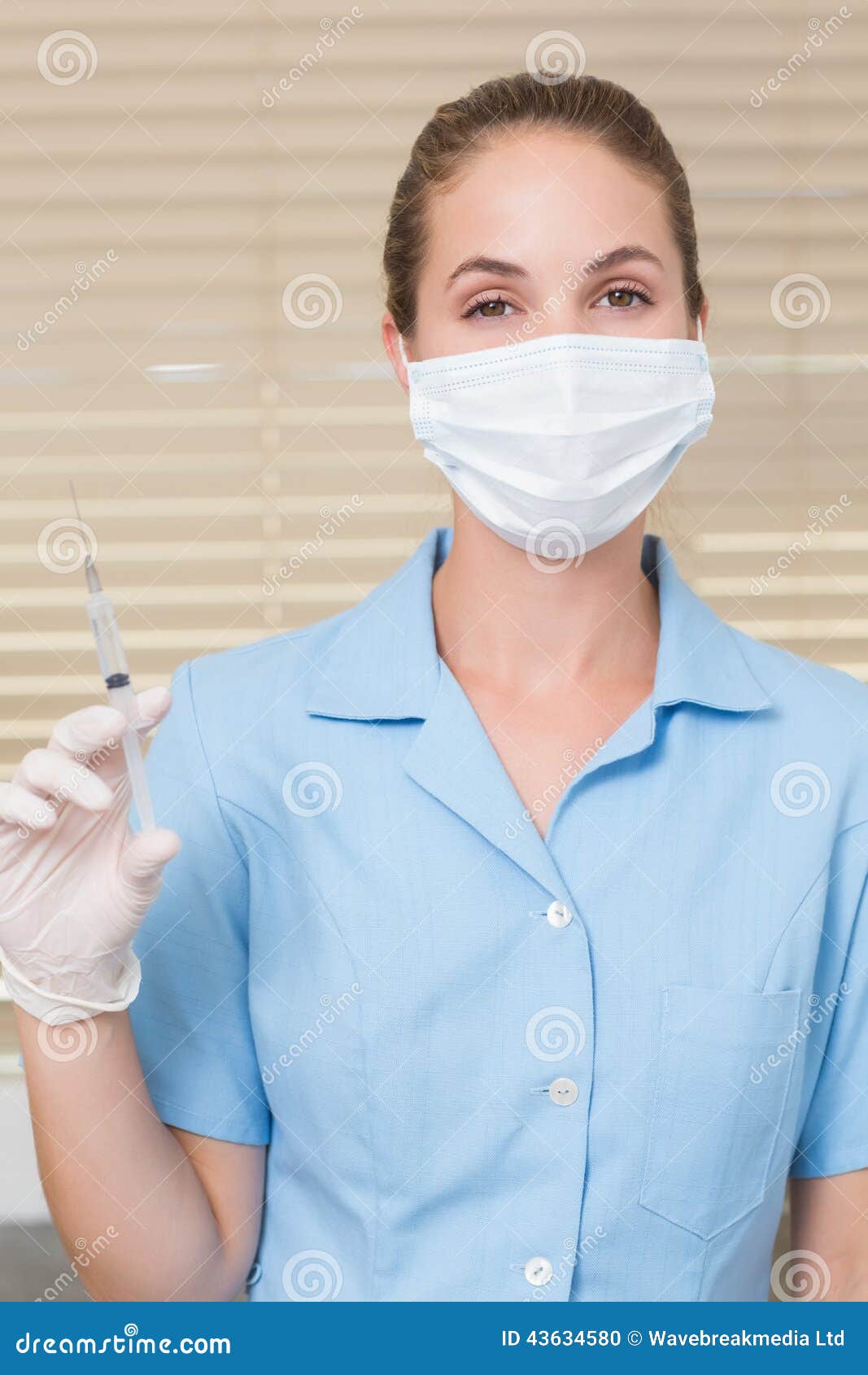 Dental Assistant Holding Injection Looking at Camera Stock Photo ...