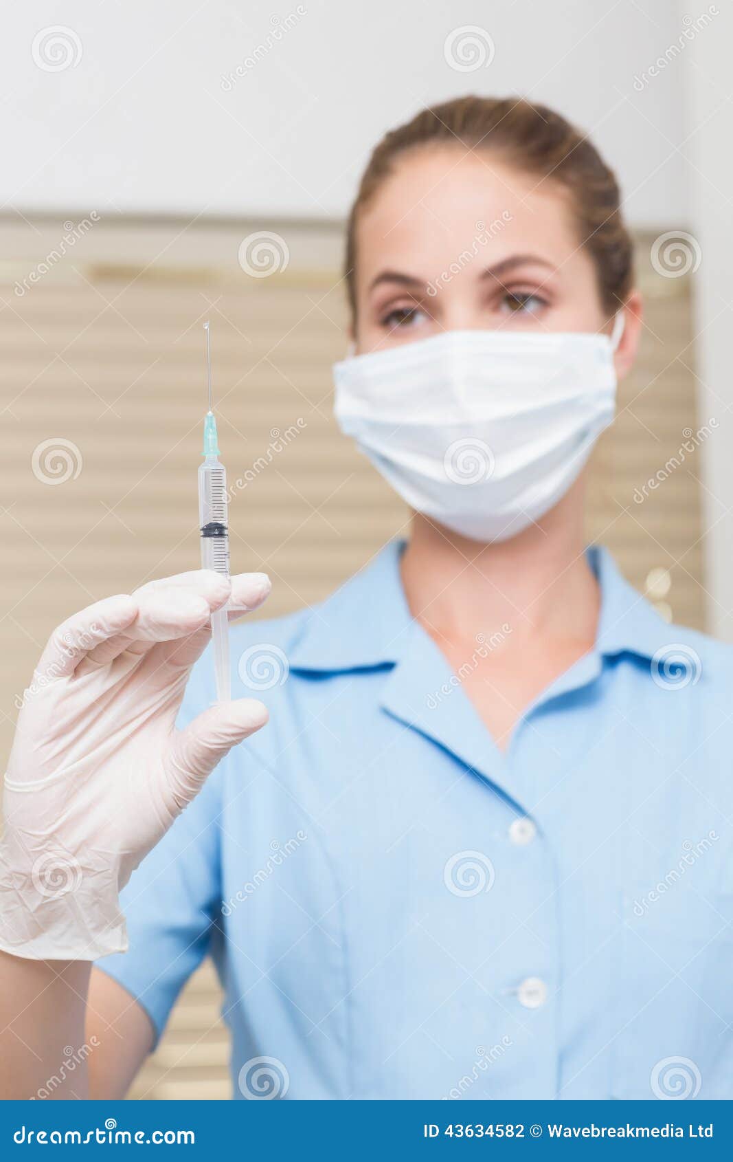 Dental Assistant Holding Injection Looking at it Stock Photo - Image of ...