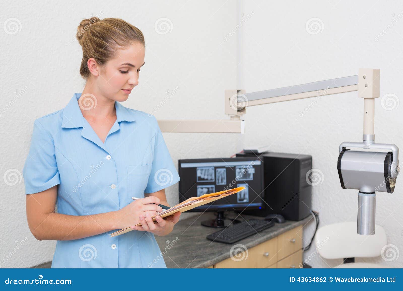 Dental Assistant Writing in Folder Stock Photo - Image of profession ...