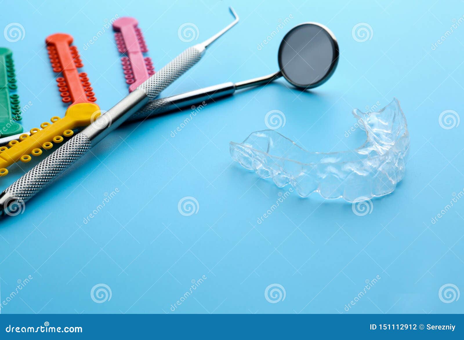 Dental Instruments and Occlusal Splint on Color Background Stock Photo ...