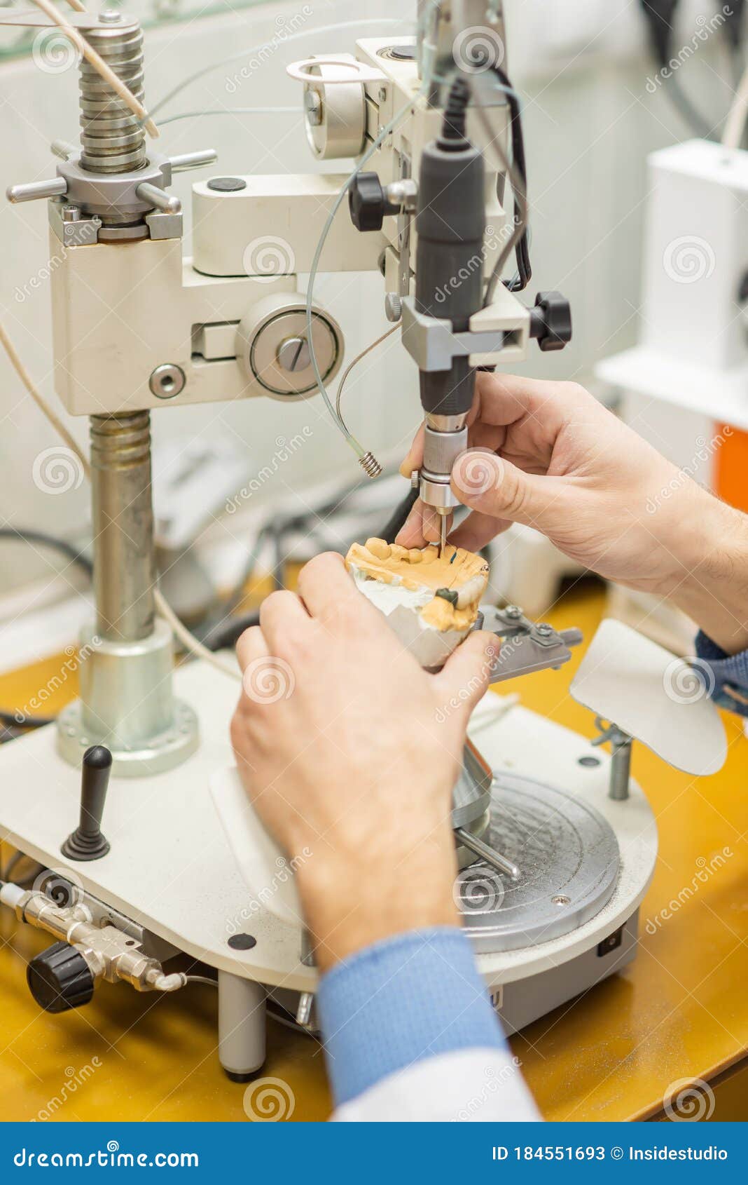 A Dental Technician Makes Partial Dentures on a Mechanized Machine. the ...
