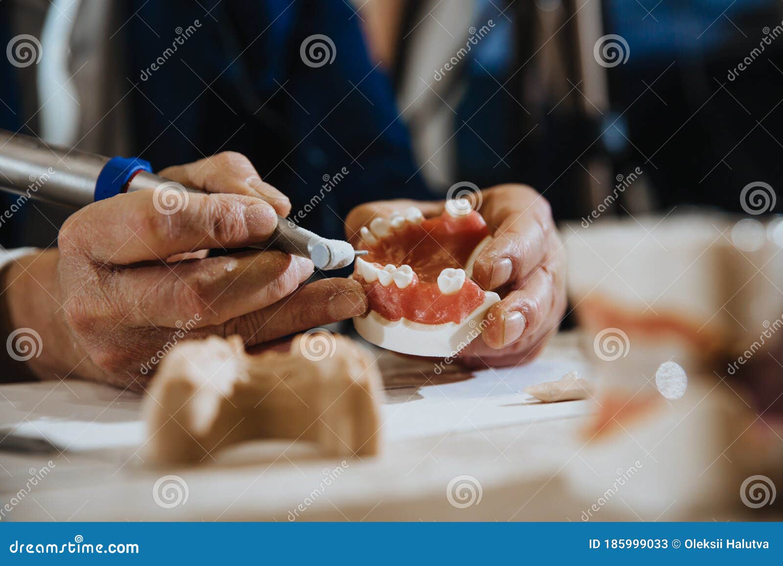 A Dental Technician Processes a Cast of the Jaw Stock Image - Image of ...